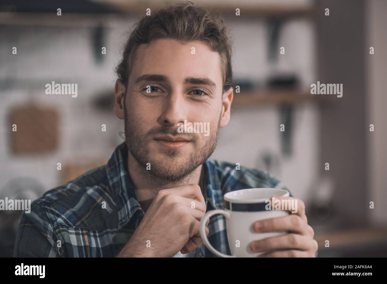 Handsome man having a cup of hot coffee Stock Photo - Alamy
