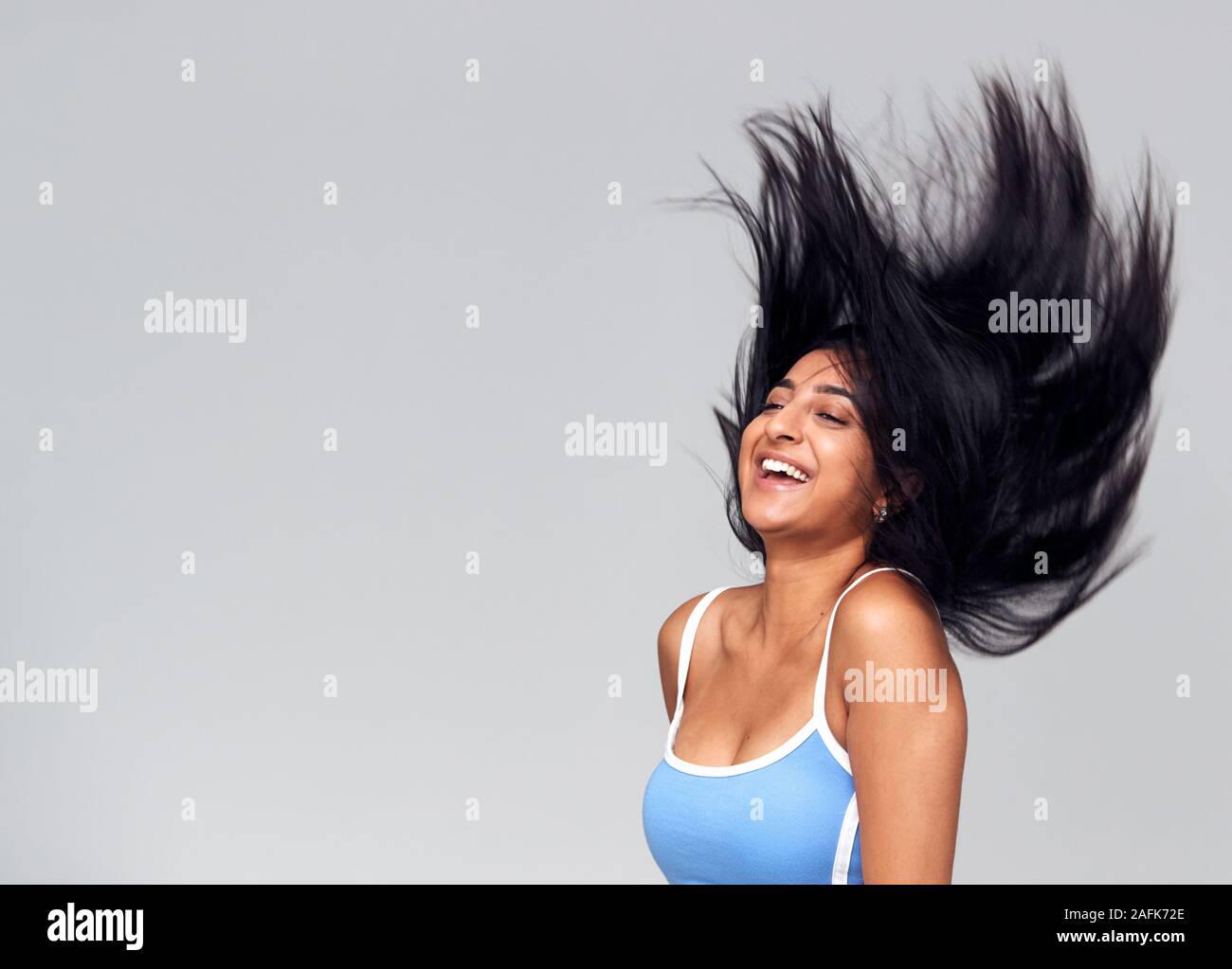 Studio Portrait Of Positive Happy Young Woman Flicking Long Hair Stock ...