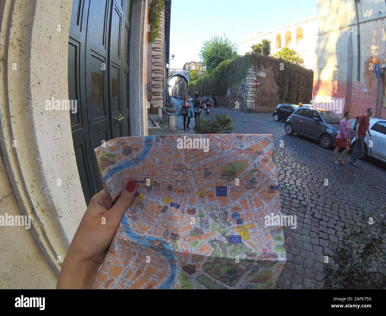 Woman holds in her left hand a tourist map of Rome close to Arco ...