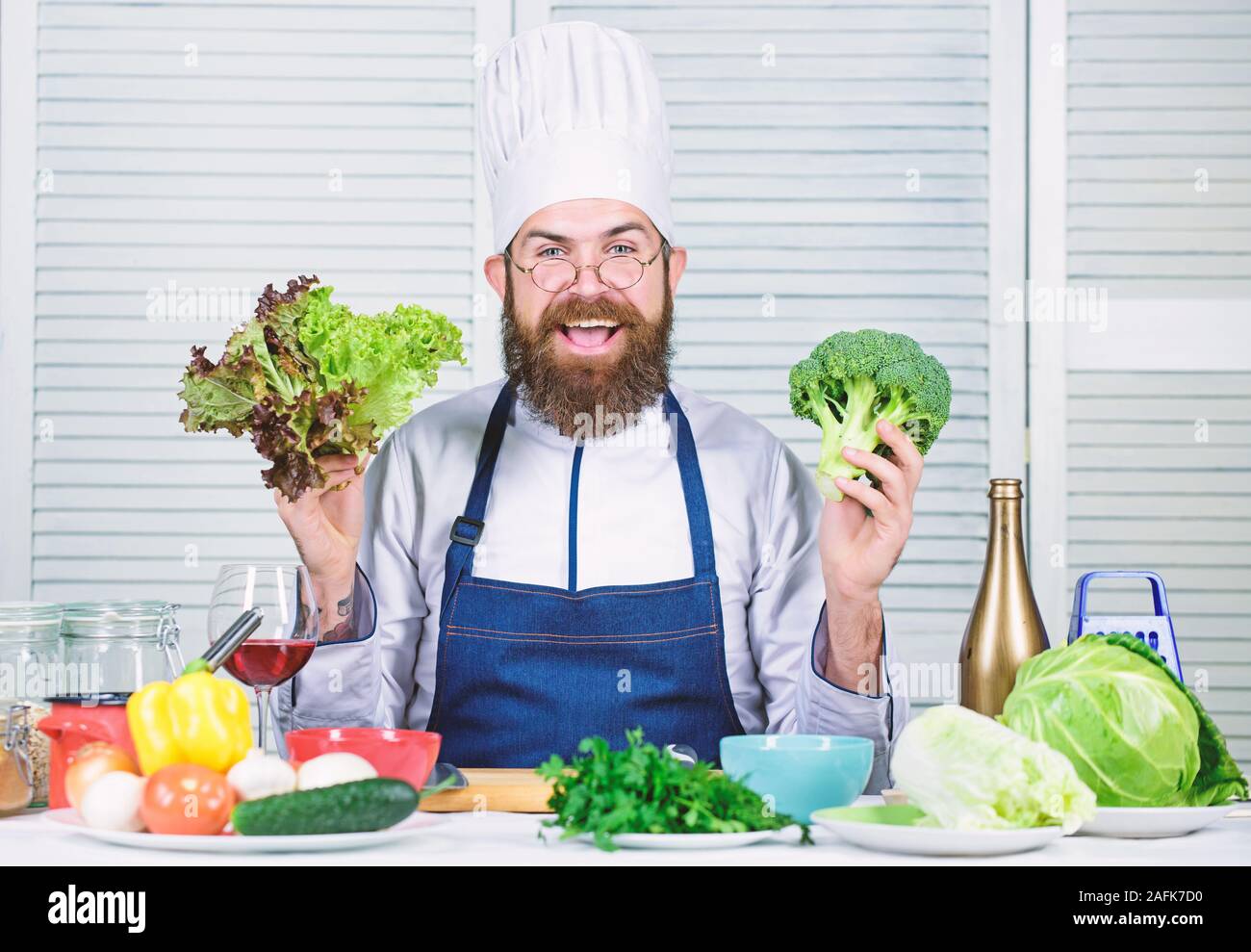 I choose only healthy ingredients. Man cook hat and apron hold broccoli ...