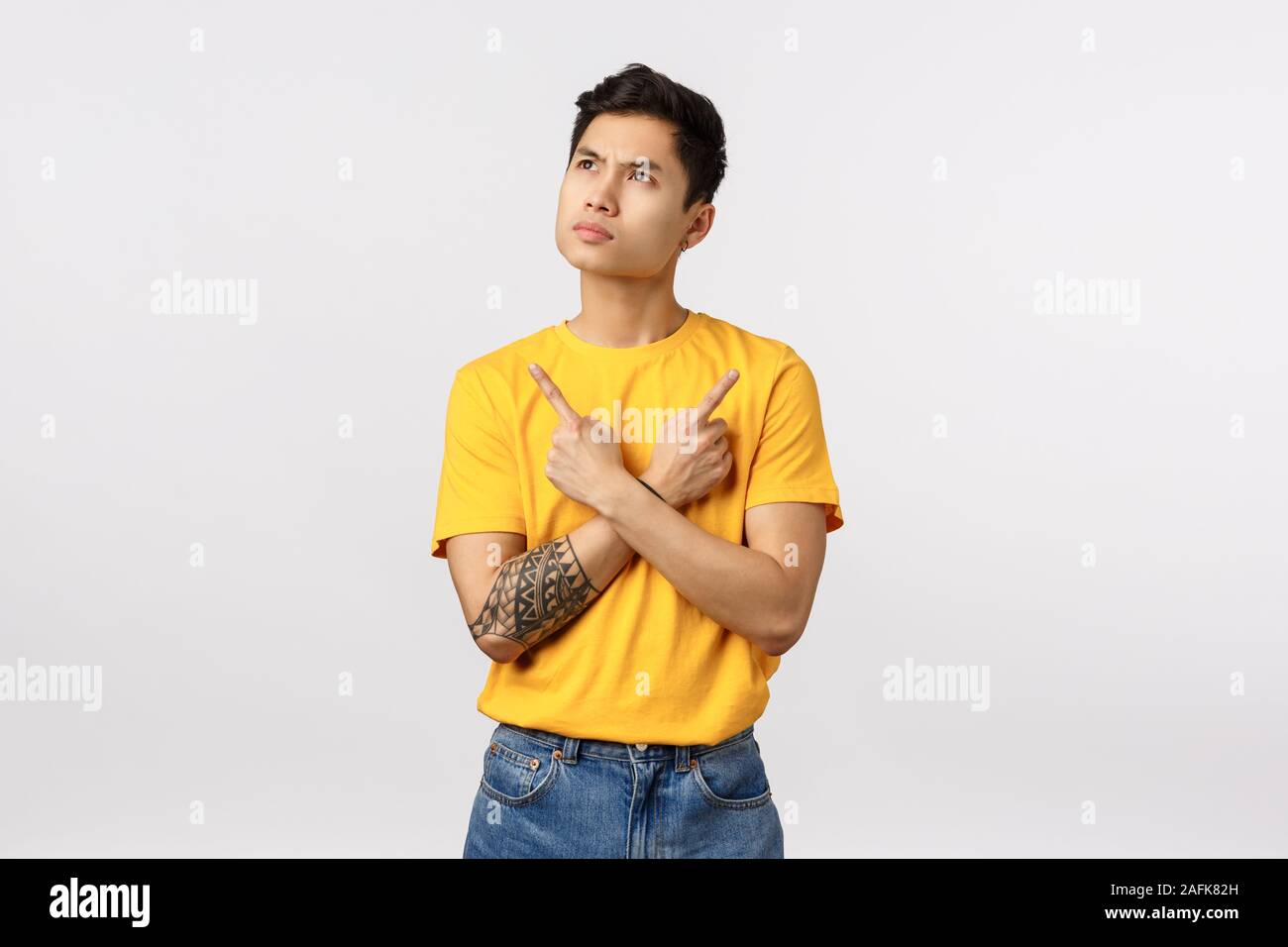 Thoughtful, serious-looking young asian male student thinking what ...
