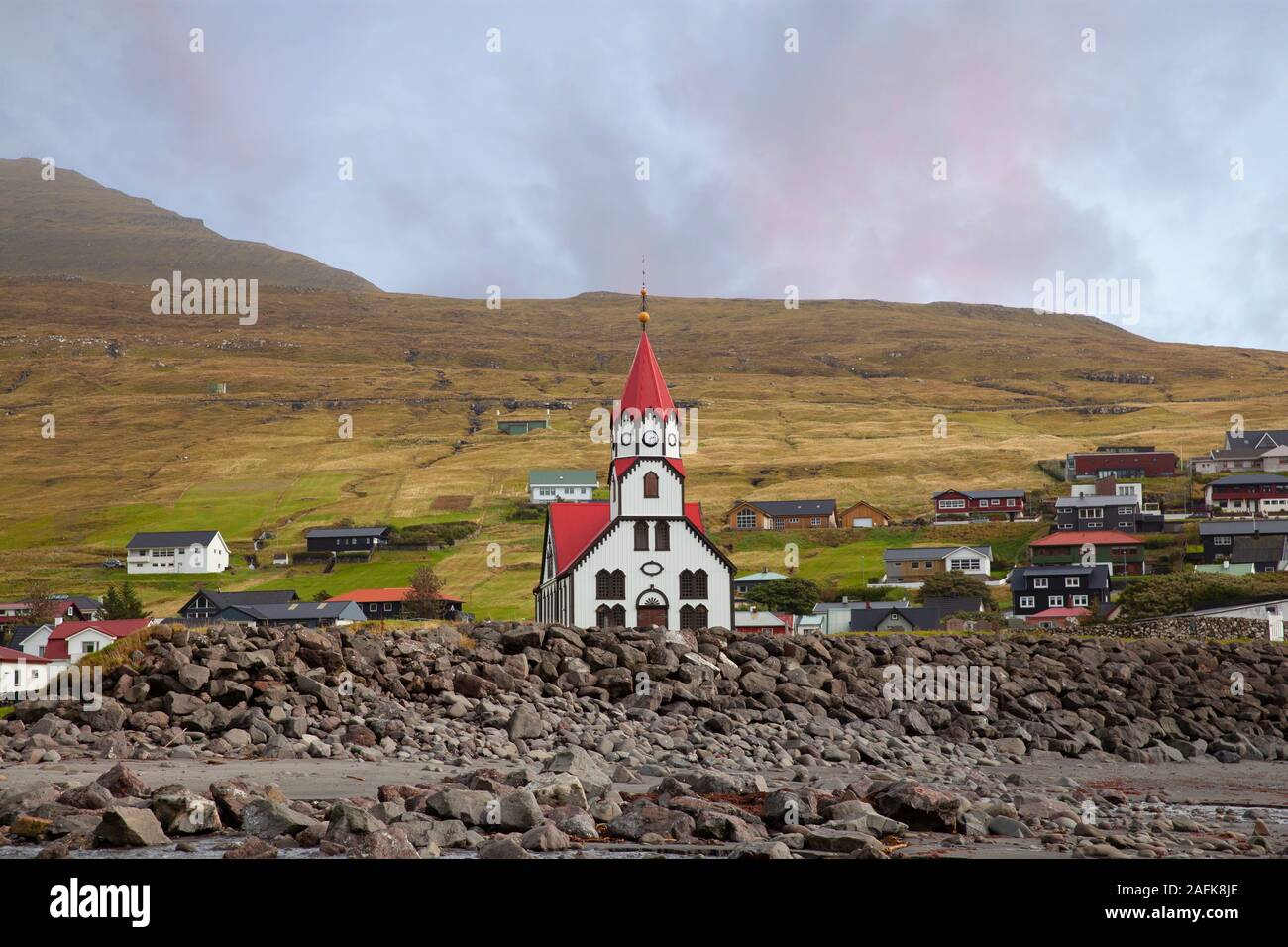 Sandavagur Church with red roof also called Sandavags Kirkja and the ...