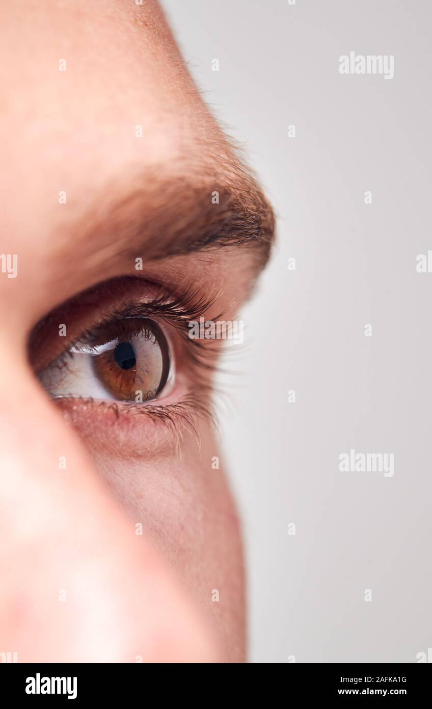 Extreme Close Up Of Eye Of Man Against White Studio Background Stock ...
