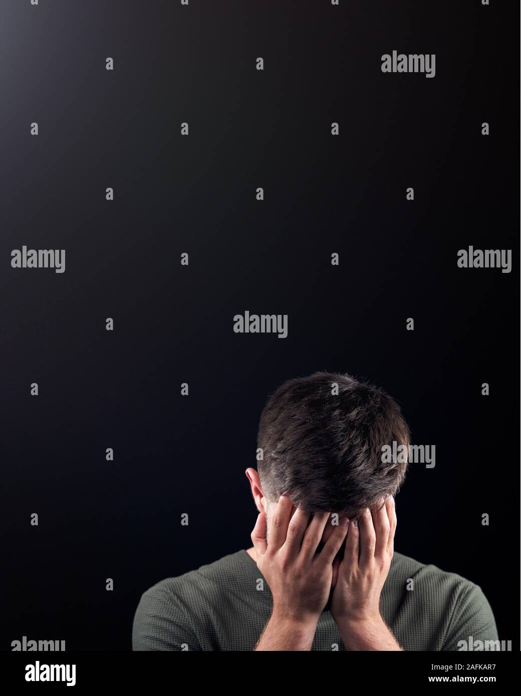 Studio Portrait Of Ashamed Young Man Covering Face With Hands Stock ...