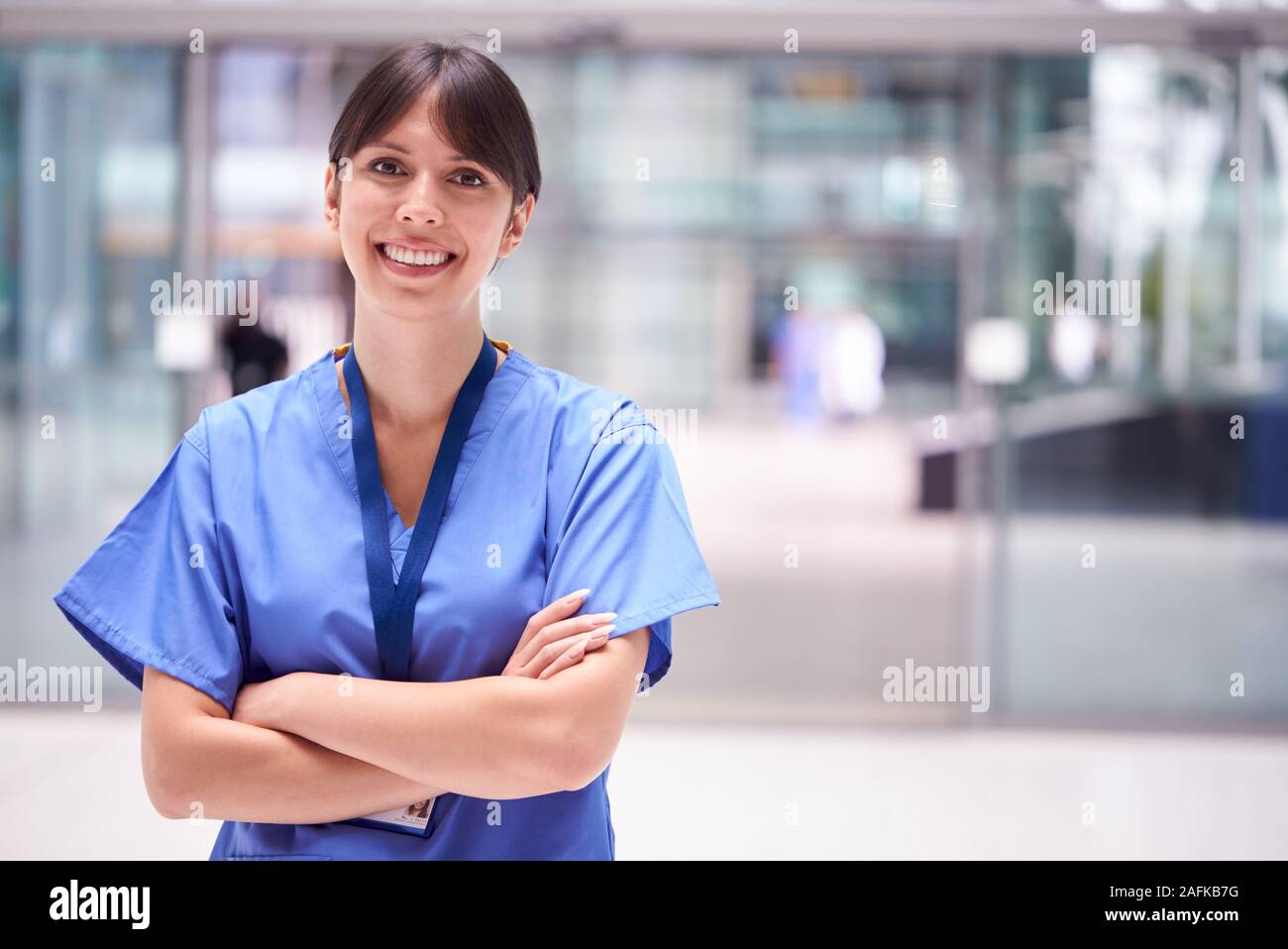 Portrait Of Female Doctor Wearing Scrubs Standing In Modern Hospital ...
