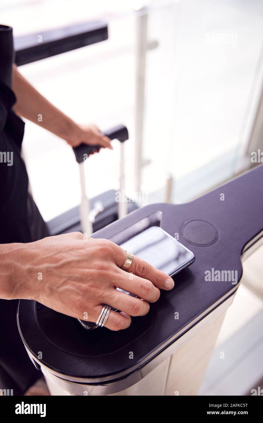 Close Up Of Passenger In Airport Departure Lounge Scanning Digital ...