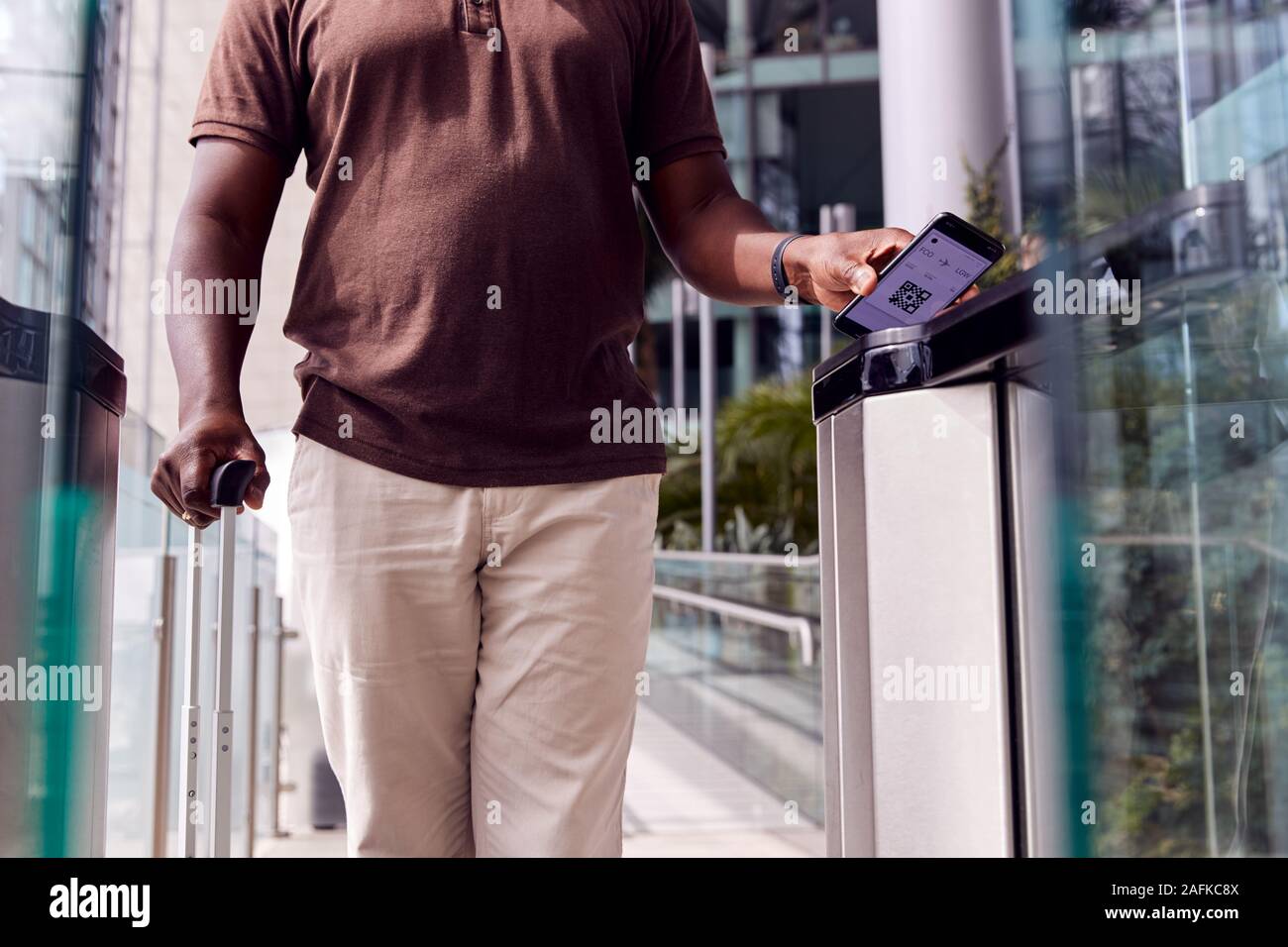Male Passenger In Airport Departure Lounge Scanning Digital Boarding ...