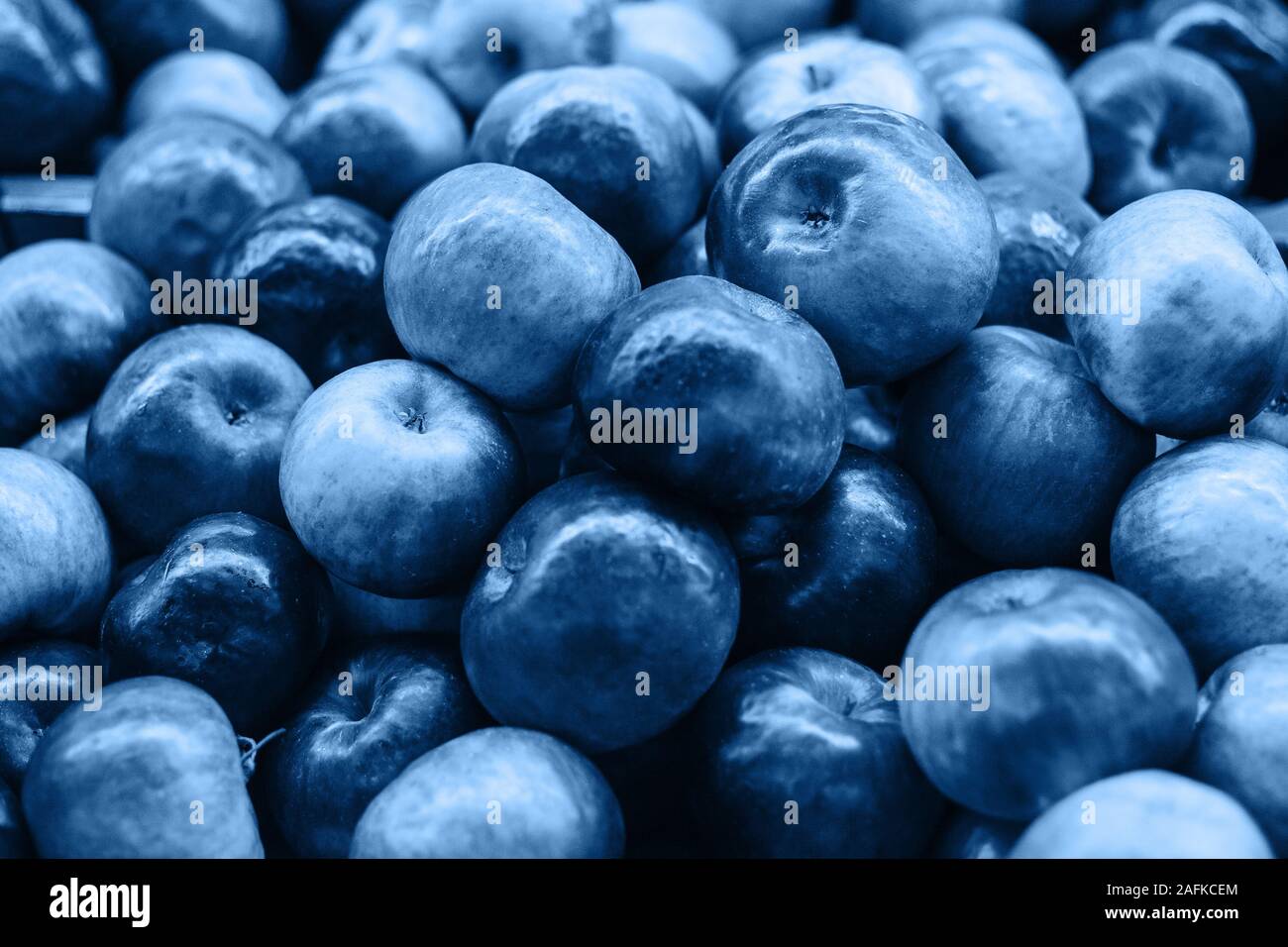 Closeup apples background in trendy classic blue color Stock Photo - Alamy
