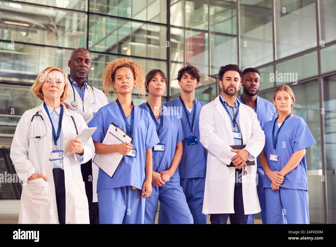Portrait Of Serious Medical Team Standing In Modern Hospital Building ...