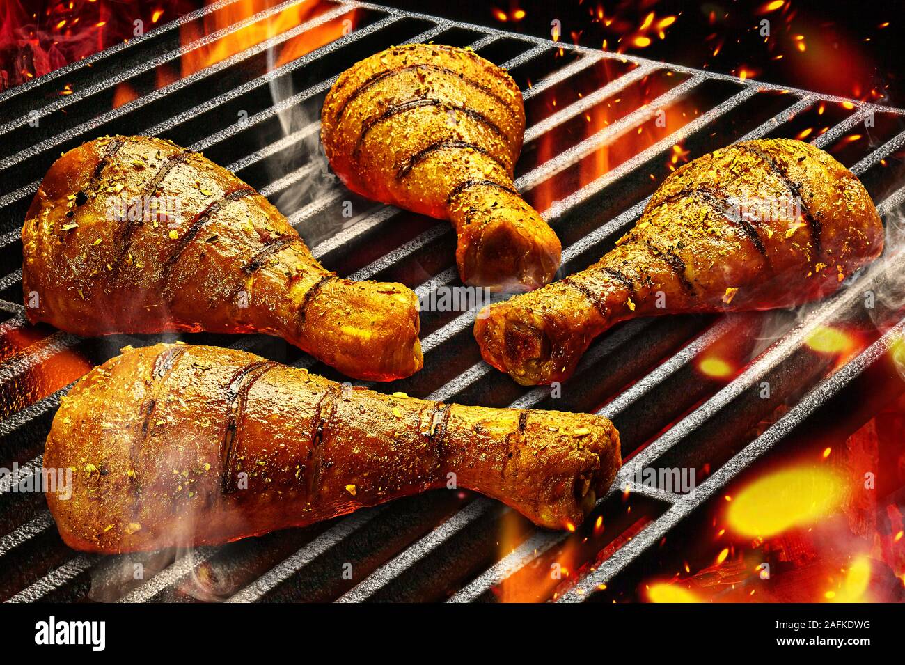 Grilled chicken Legs on the grill fire Stock Photo - Alamy