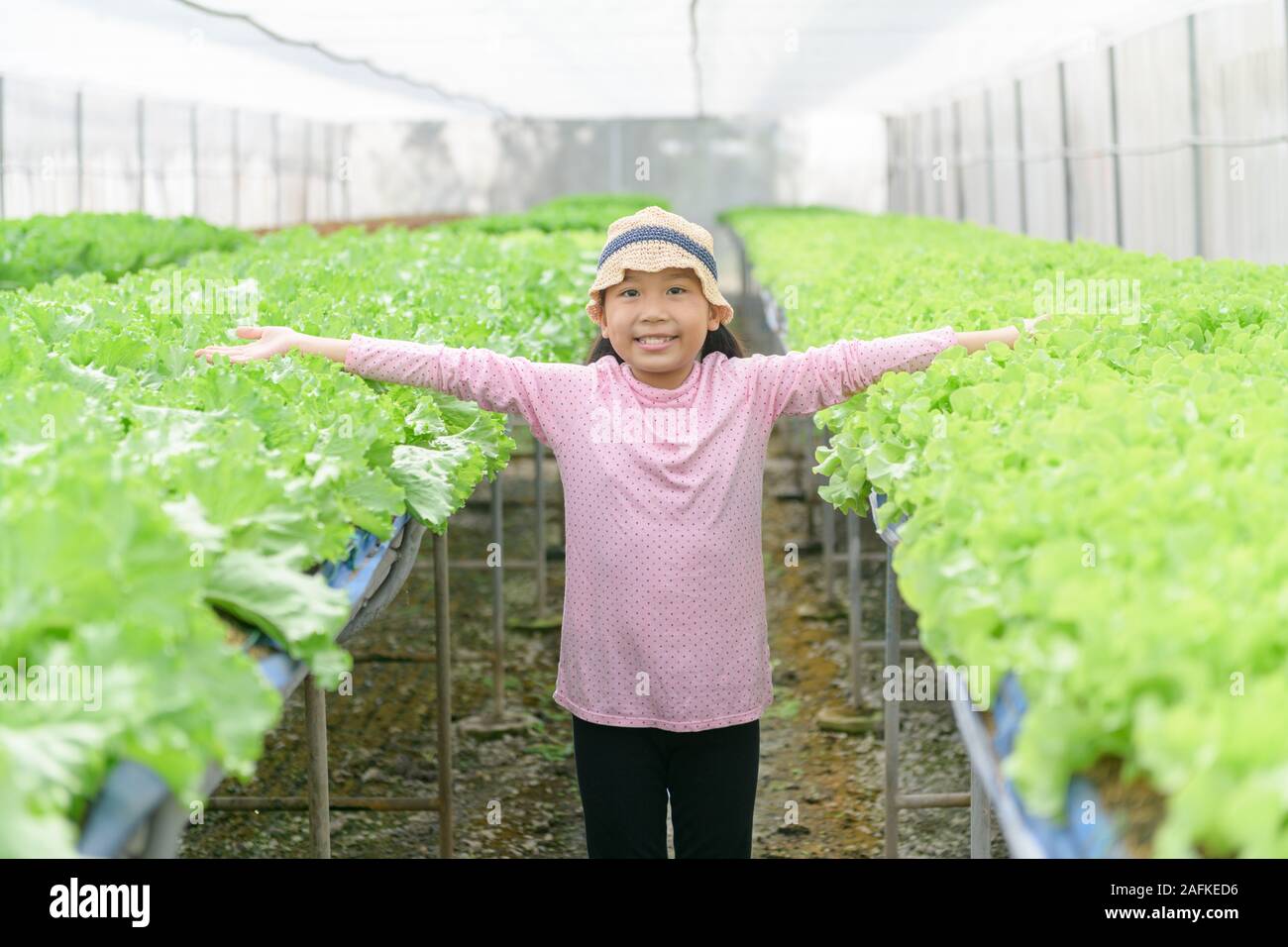 Happy cute asian girl smiling and presenting with hand to organic ...