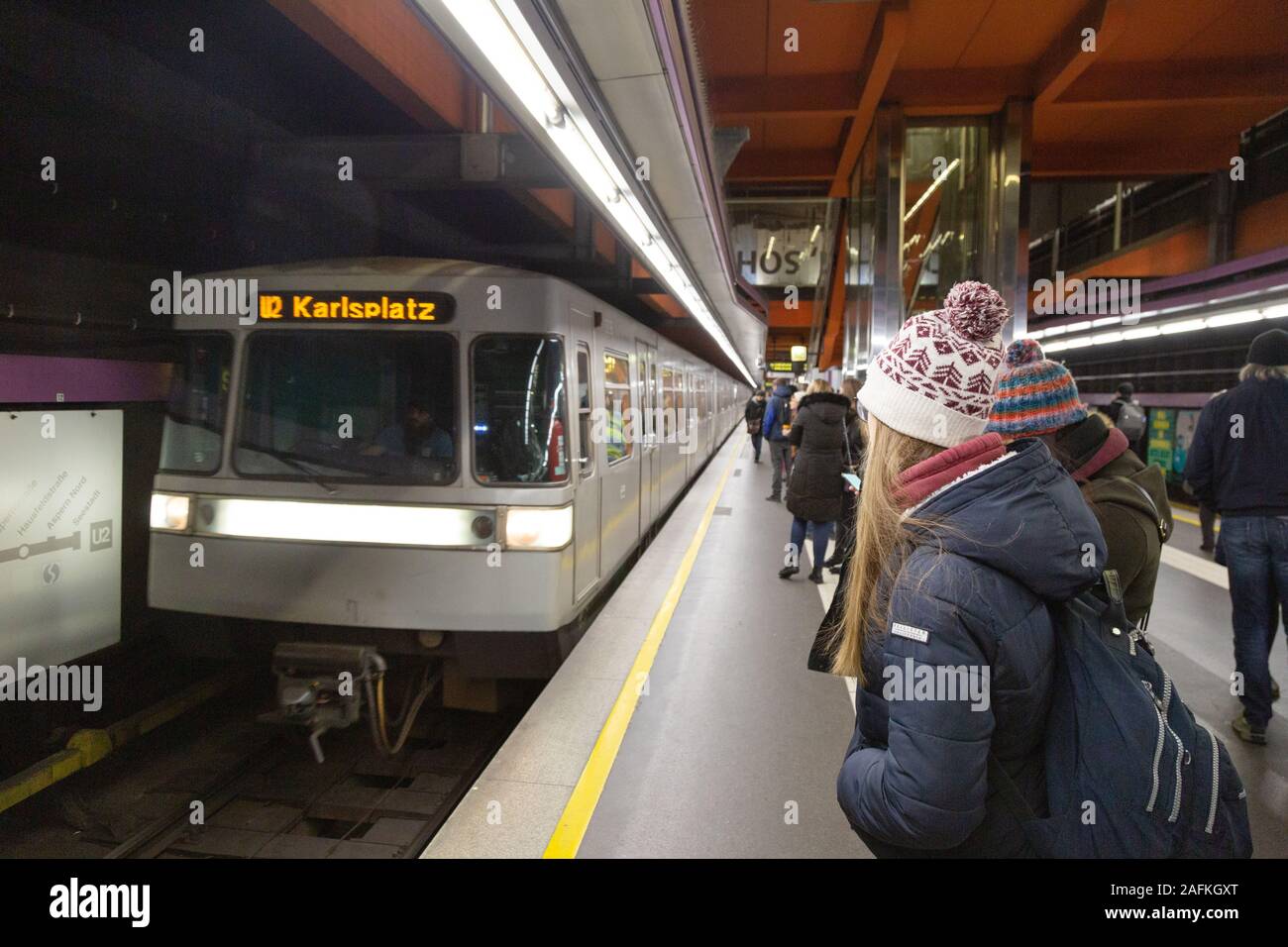 Vienna U- Bahn, a train arriving at the station with people waiting ...