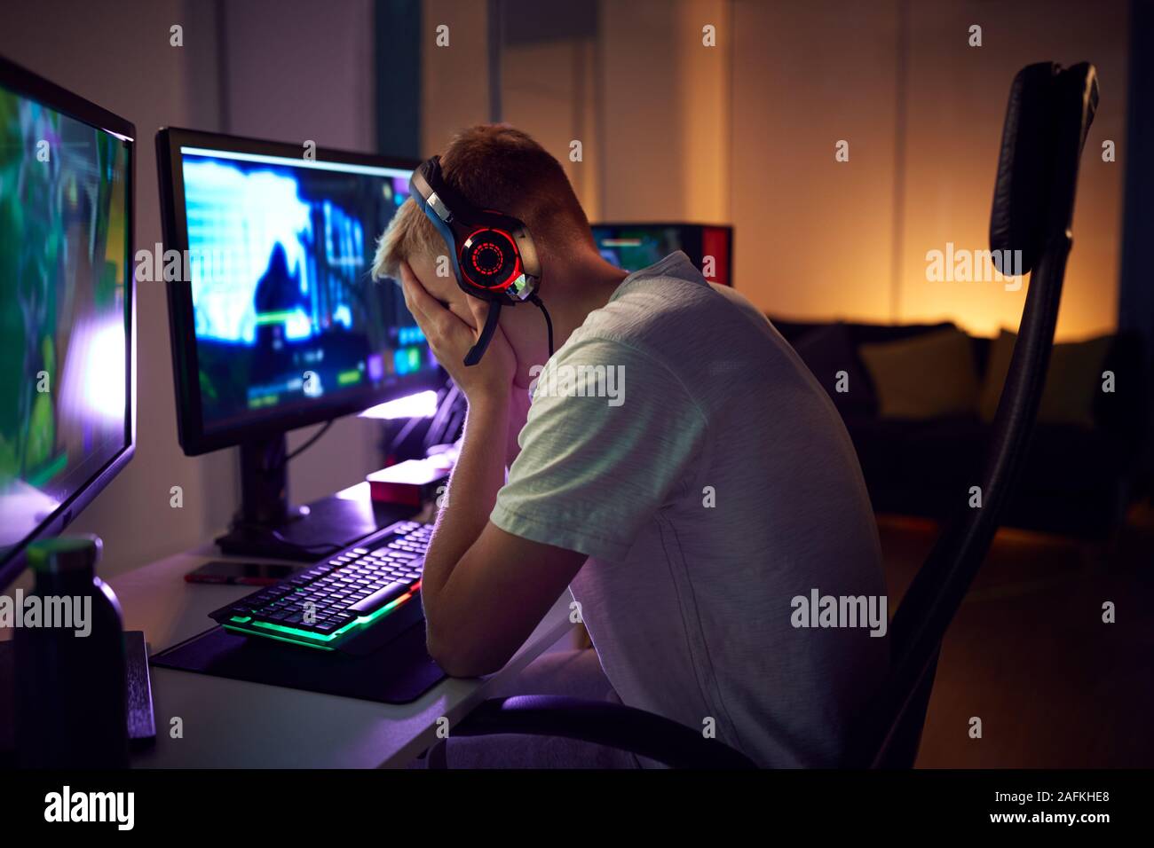 Stressed Teenage Boy Being Bullied Online Whilst Gaming At Home Stock ...