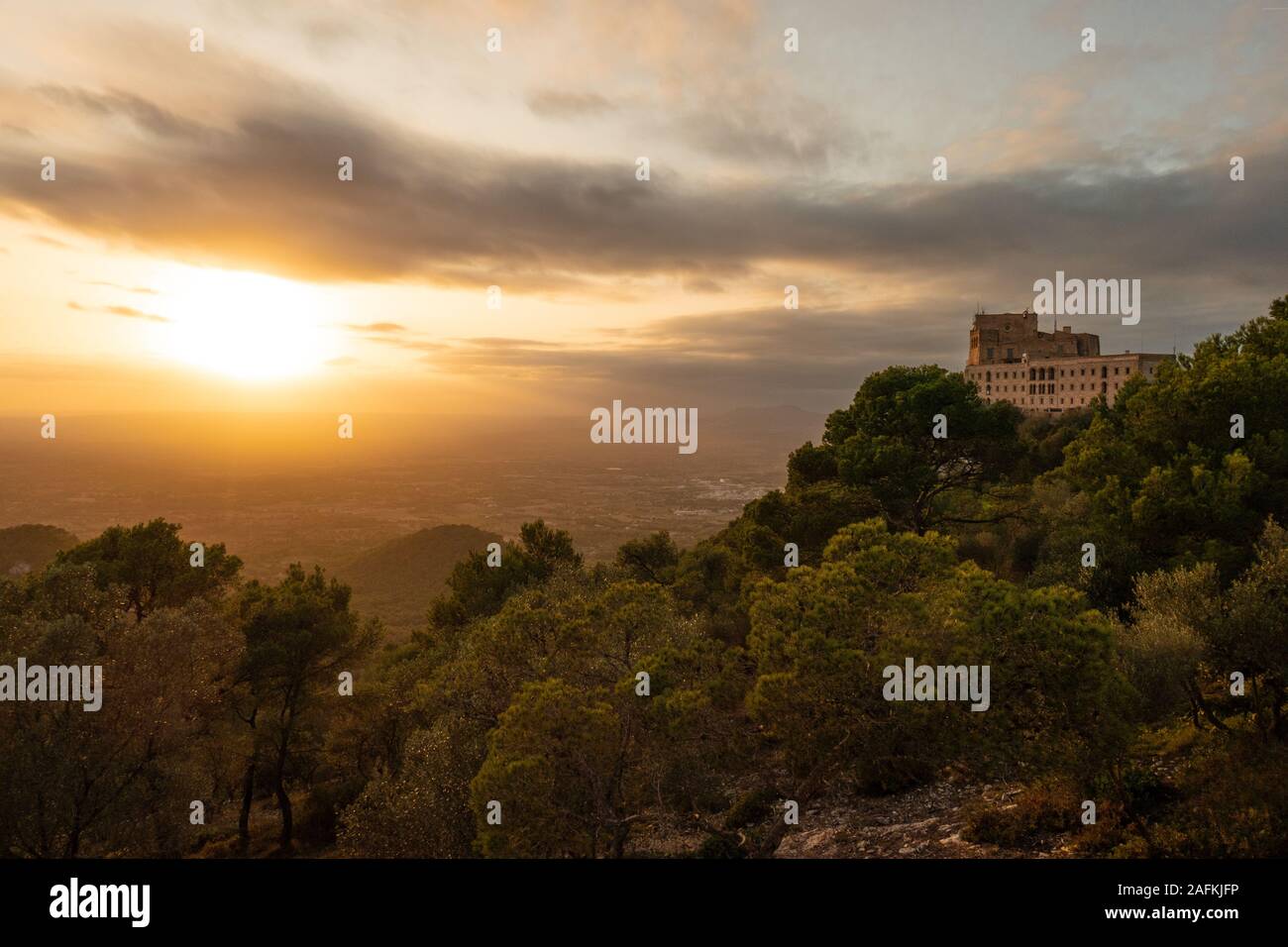 View at monastery at hill at sunset with lovely light Stock Photo - Alamy