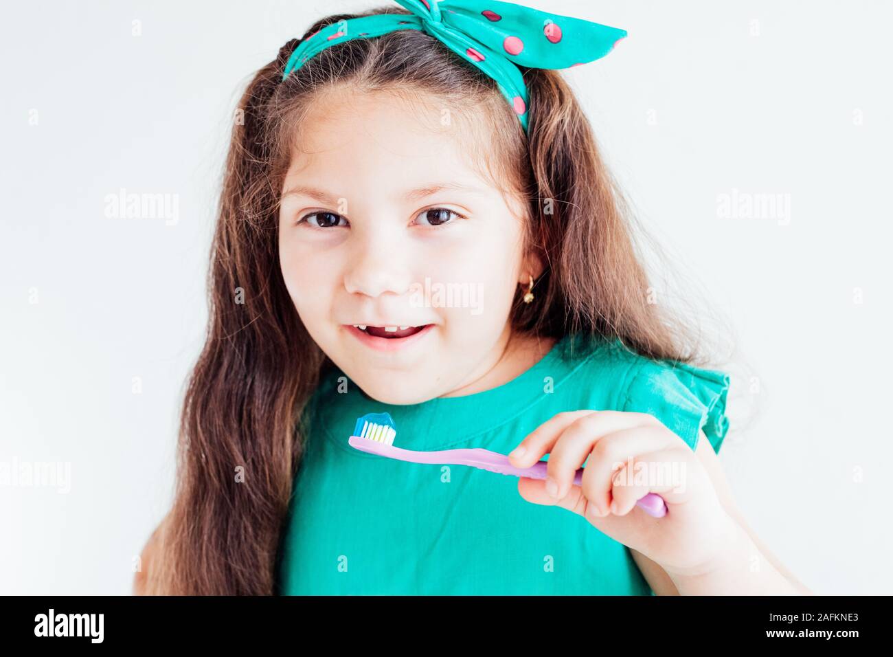 little girl with no teeth with a toothbrush in dentistry Stock Photo ...