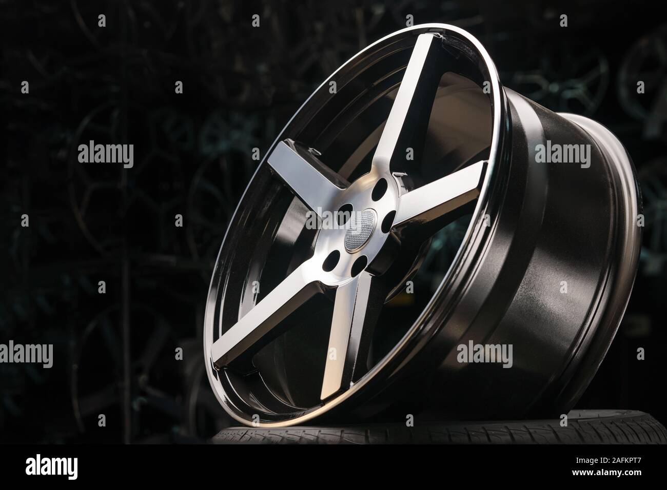 cast aluminum disc alloy wheel modern, close-up on black background ...