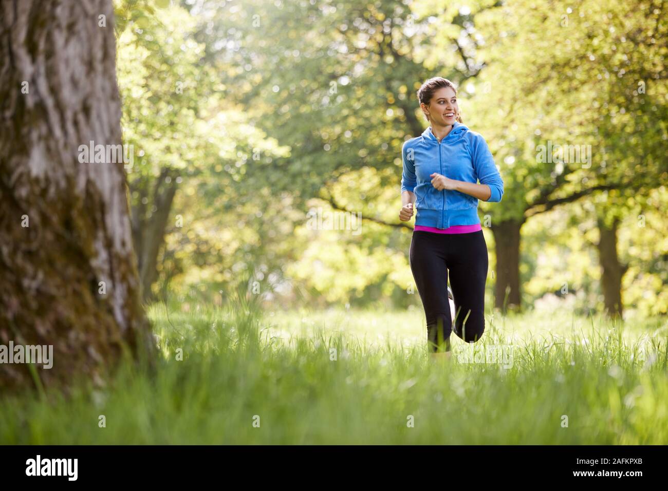 Woman running through field hi-res stock photography and images - Alamy