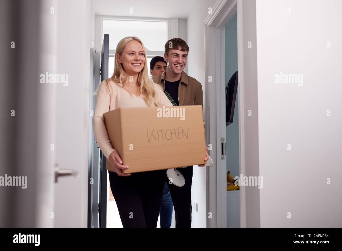 Group Of College Student Carrying Boxes Moving Into Accommodation ...
