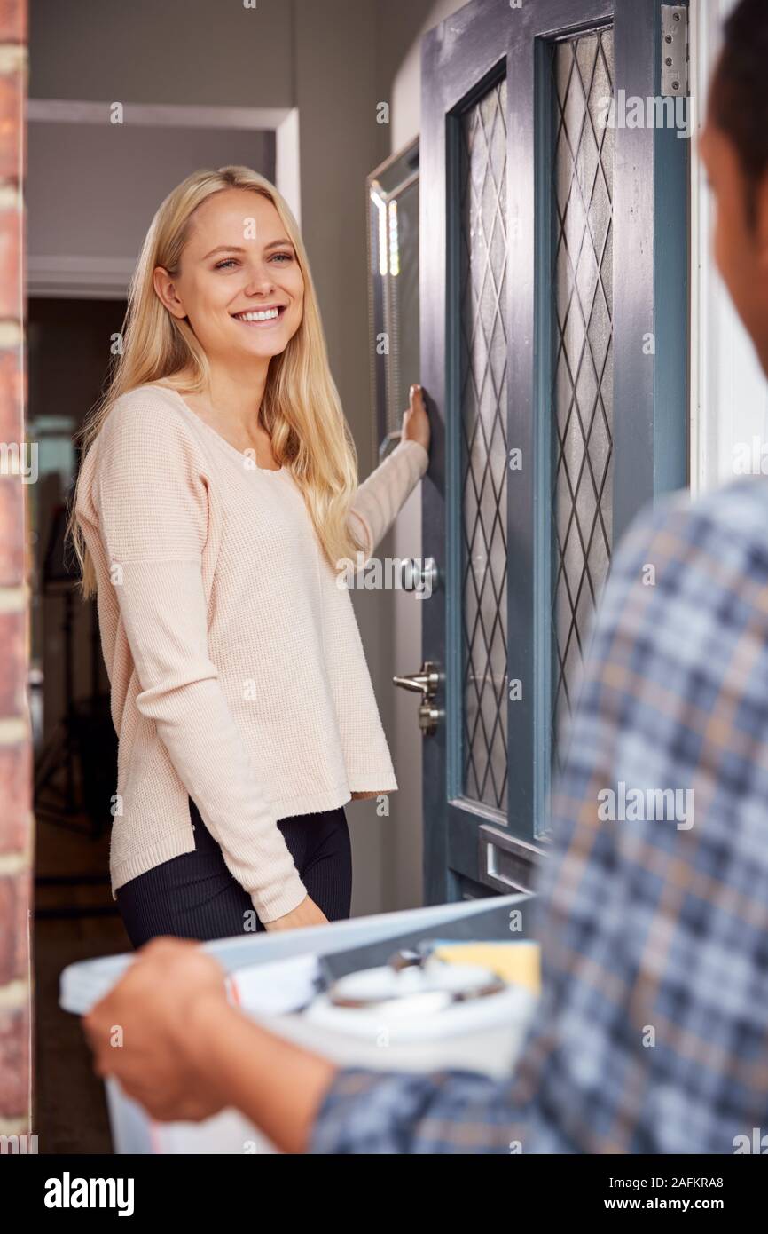 Male College Student Carrying Box Moving Into Accommodation Meeting ...