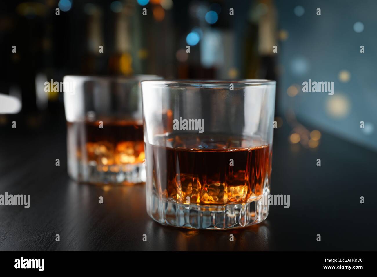 Glasses of whiskey on bar counter, close up and space for text Stock ...