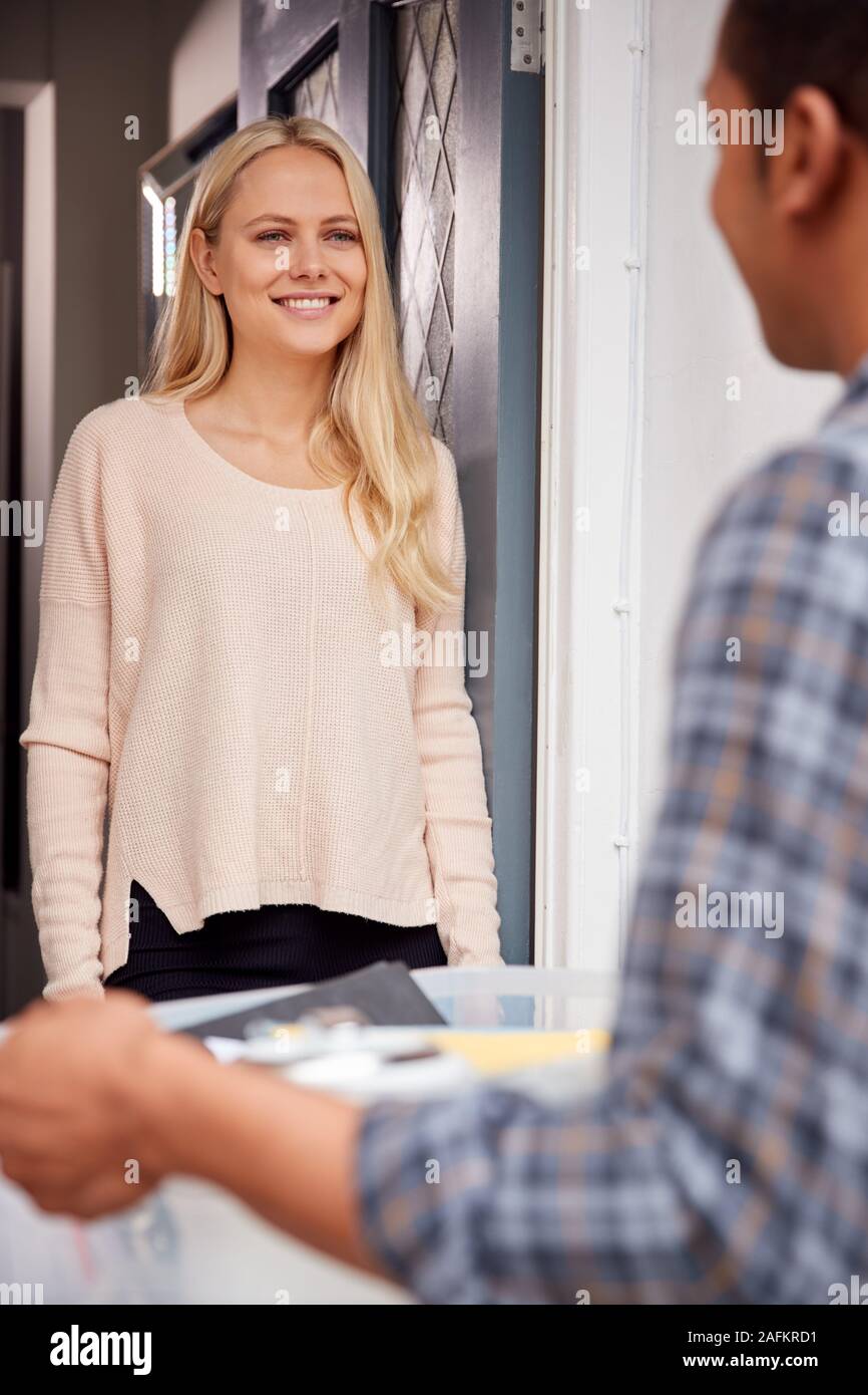 Male College Student Carrying Box Moving Into Accommodation Meeting ...