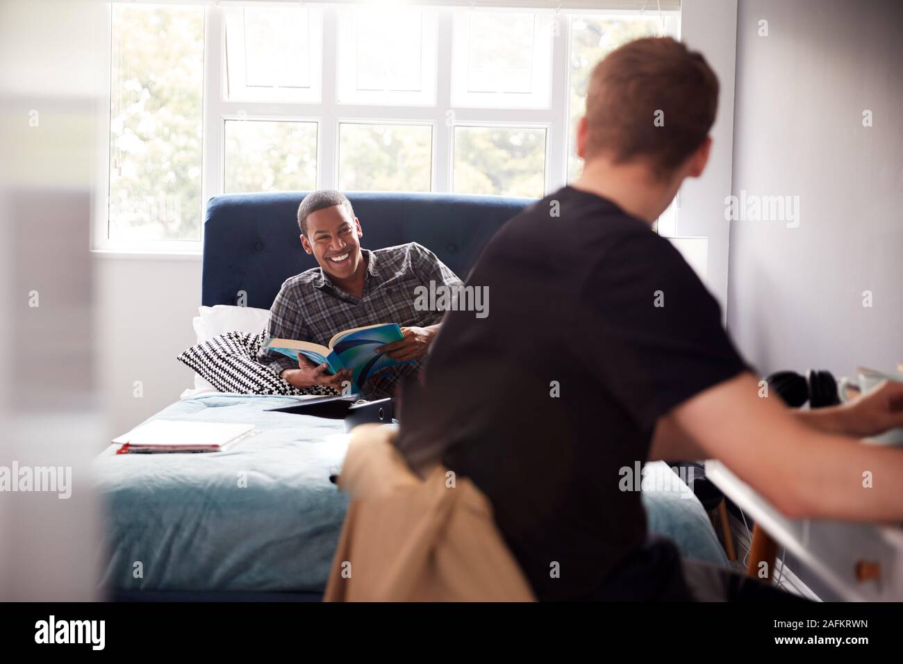 Two Male College Students In Shared House Bedroom Studying Together ...