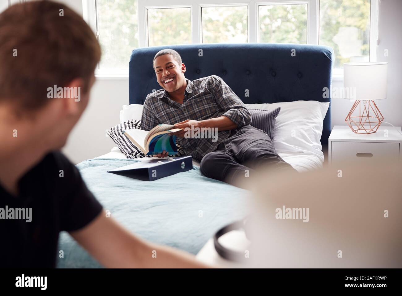 Two Male College Students In Shared House Bedroom Studying Together ...