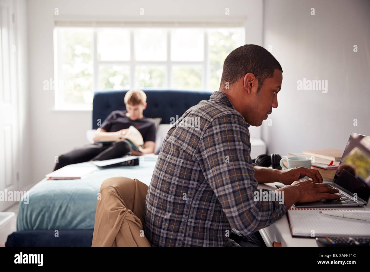 Two Male College Students In Shared House Bedroom Studying Together ...