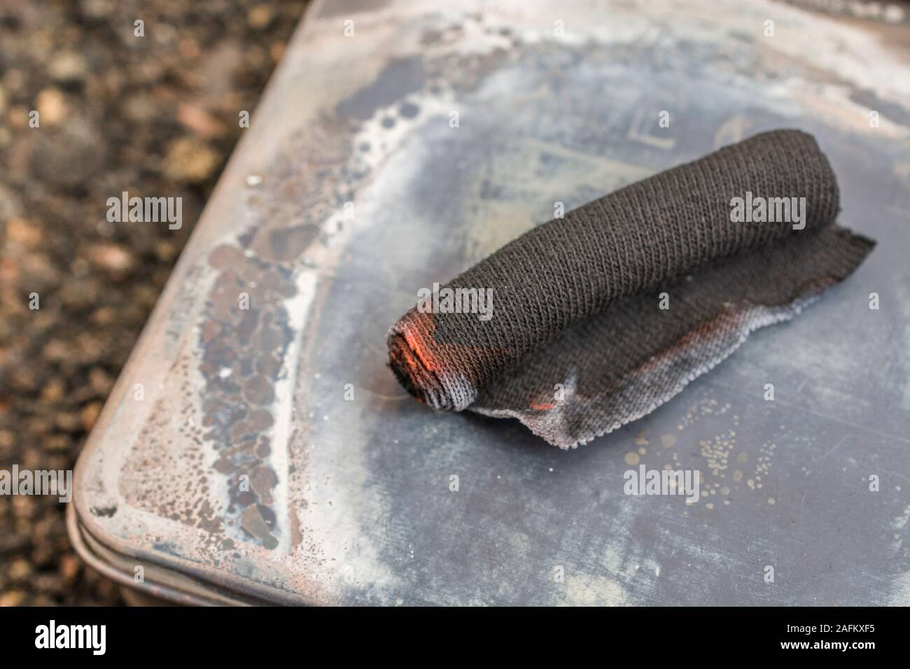 Survival skills. Close shot of burning charcloth. Material is used in ...