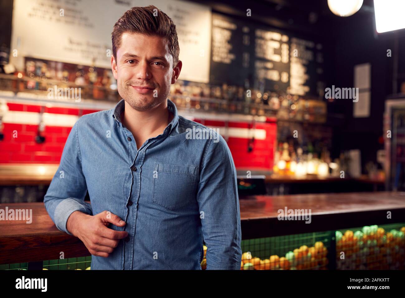 Portrait Of Male Bar Owner Standing By Counter Stock Photo - Alamy