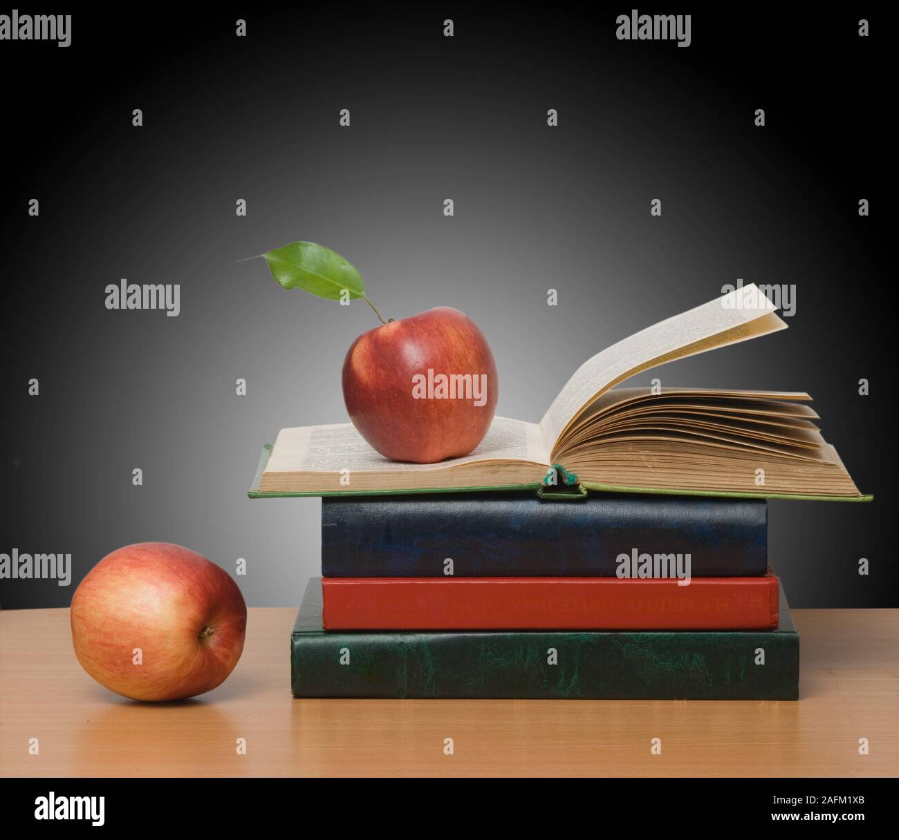Red apples and open book Stock Photo - Alamy