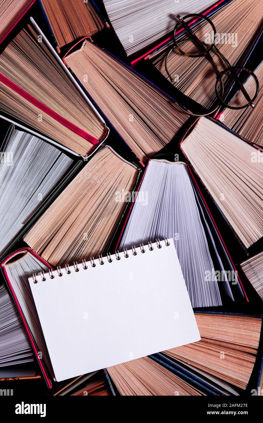 Library. Old open books stand on a bookshelf ready to read. Close-up ...