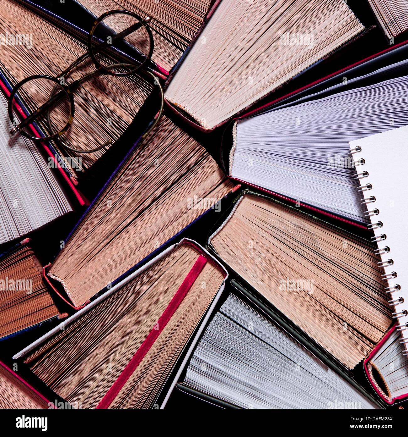 Library. Old open books stand on a bookshelf ready to read. Close-up ...