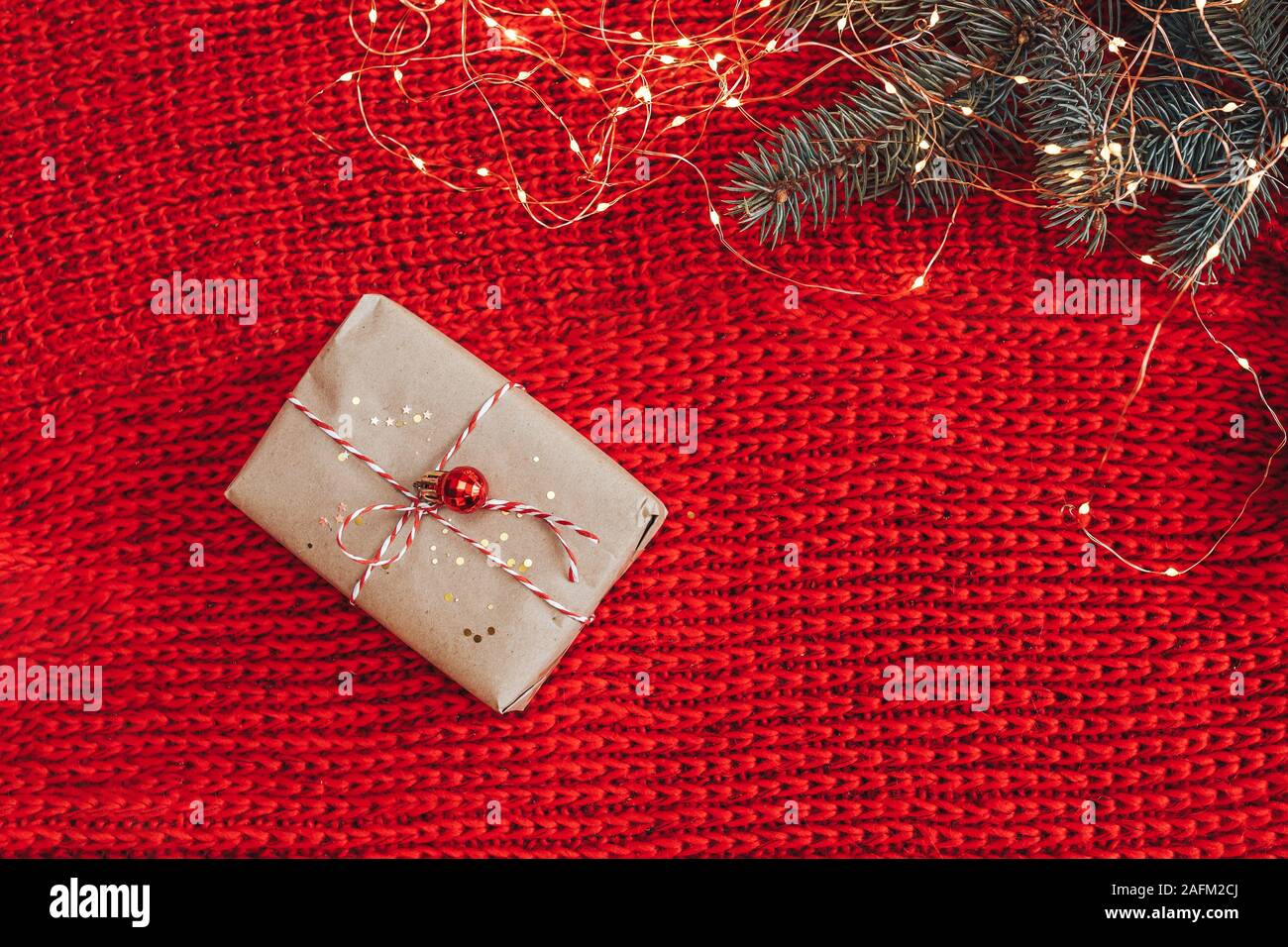 Craft rustic present on knitted red background Stock Photo - Alamy