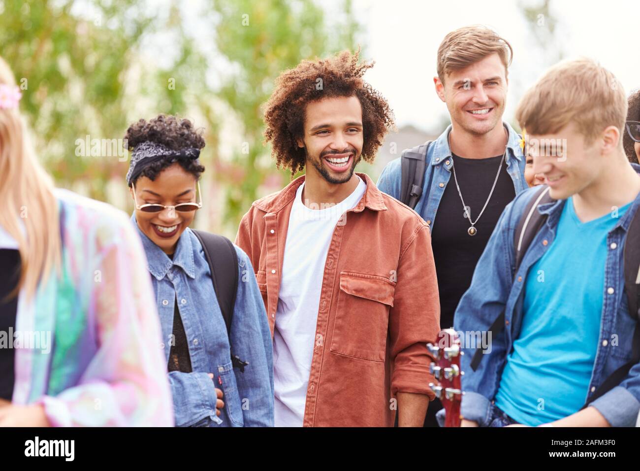 Group Of Young Friends Waiting Behind Barrier At Entrance To Music ...
