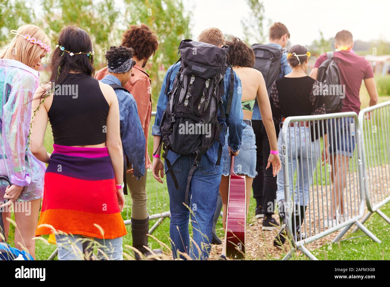 Rear View Of Friends At Entrance To Music Festival Walking Through ...