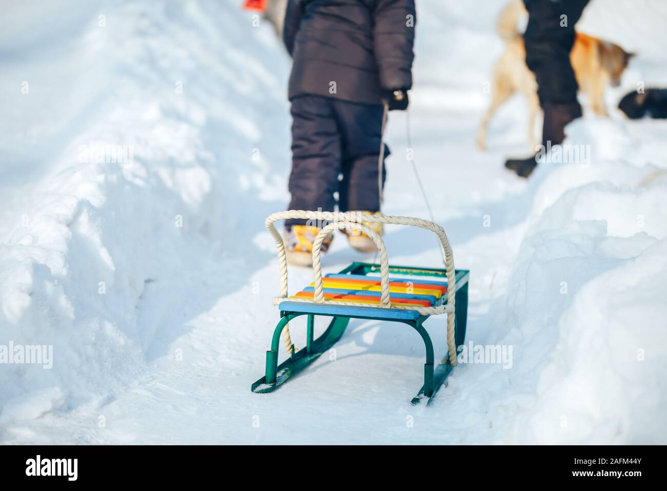 Child pulling sled up hill hi-res stock photography and images - Alamy