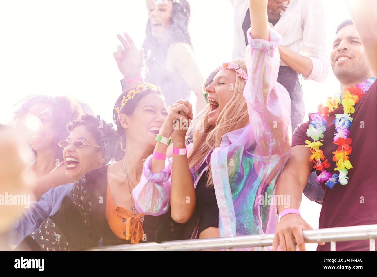 Audience With Colored Smoke Behind Barrier Dancing And Singing At ...