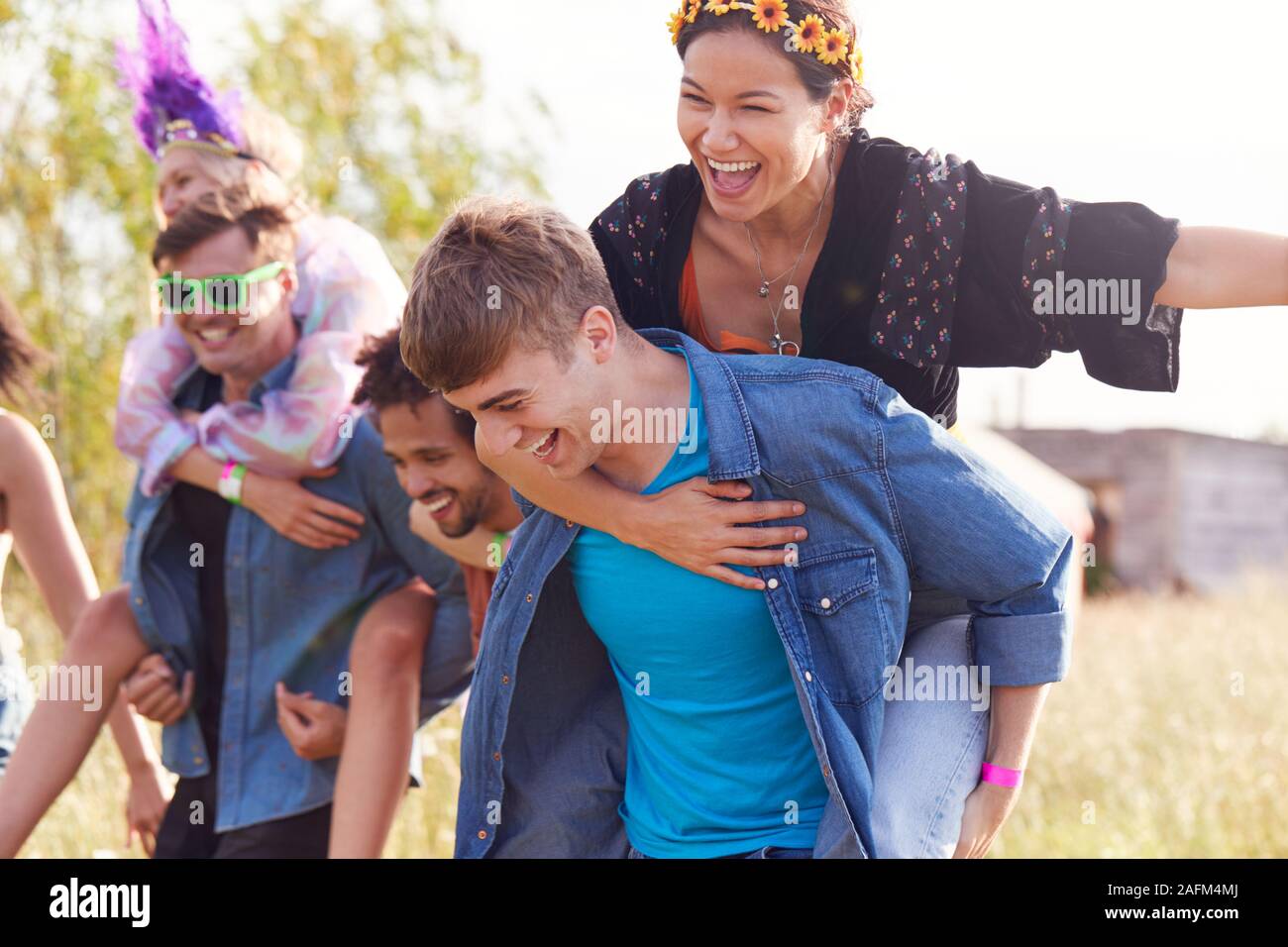 Group Of Friends Walking Back To Tent After Outdoor Music Festival With ...