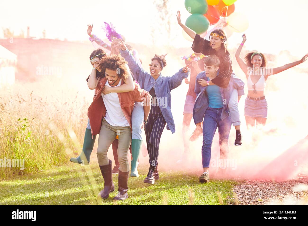 Group Of Friends Walking Back To Tent After Outdoor Music Festival With ...