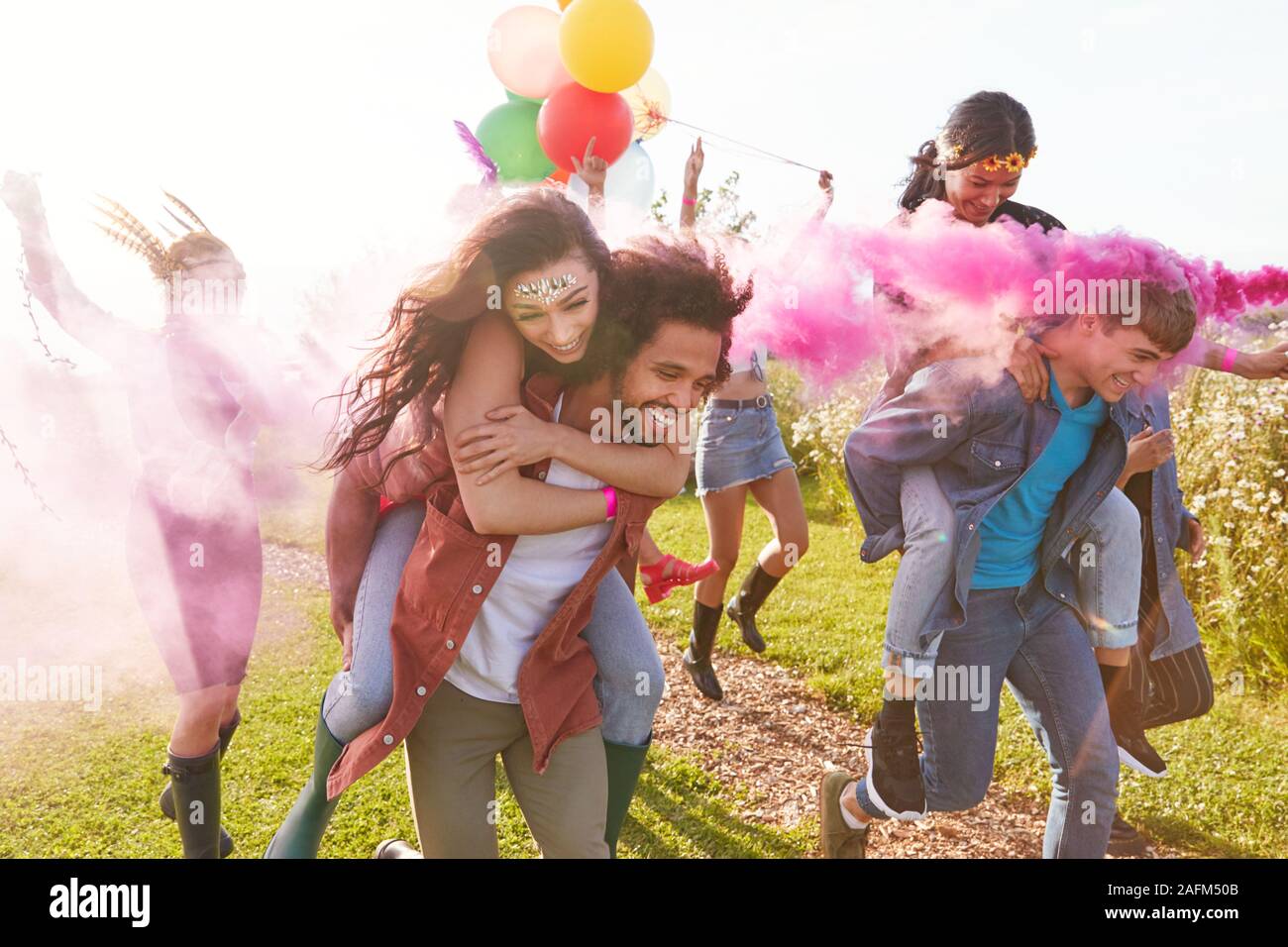 Group Of Friends Walking Back To Tent After Outdoor Music Festival With ...