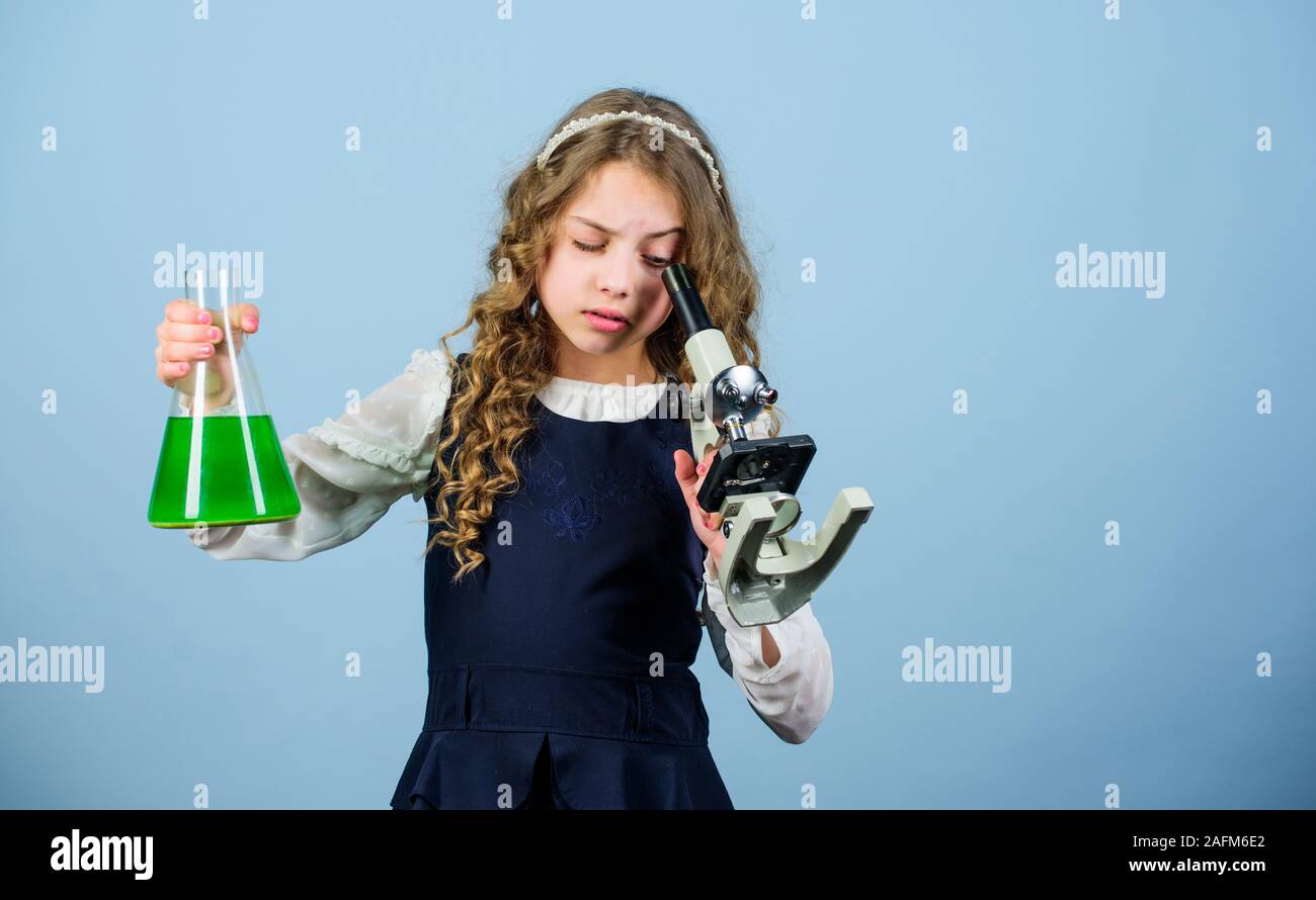 It is unbelievable. small girl scientist with testing flask. knowledge ...