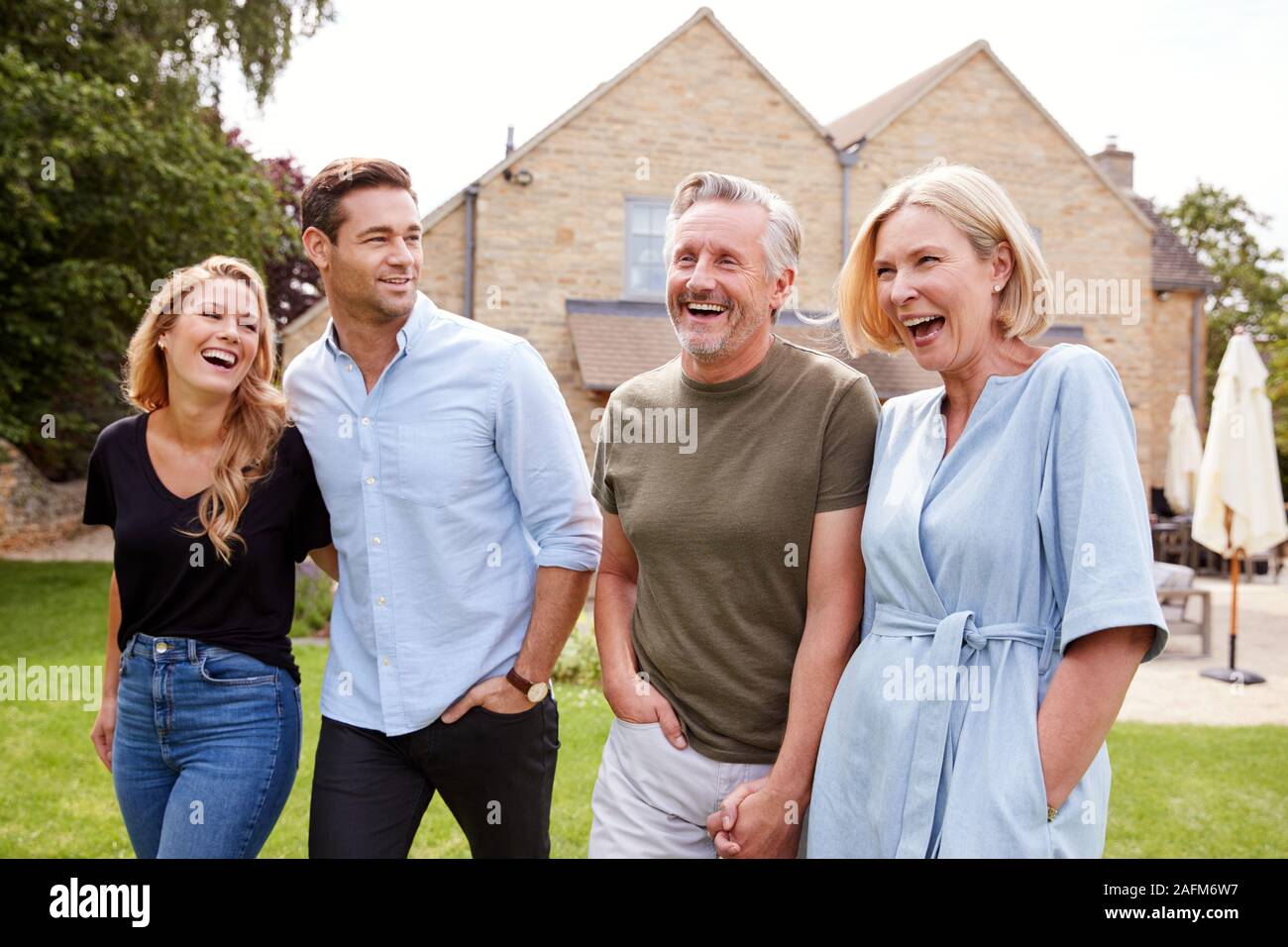 Family With Senior Parents And Adult Offspring Walking And Talking In ...