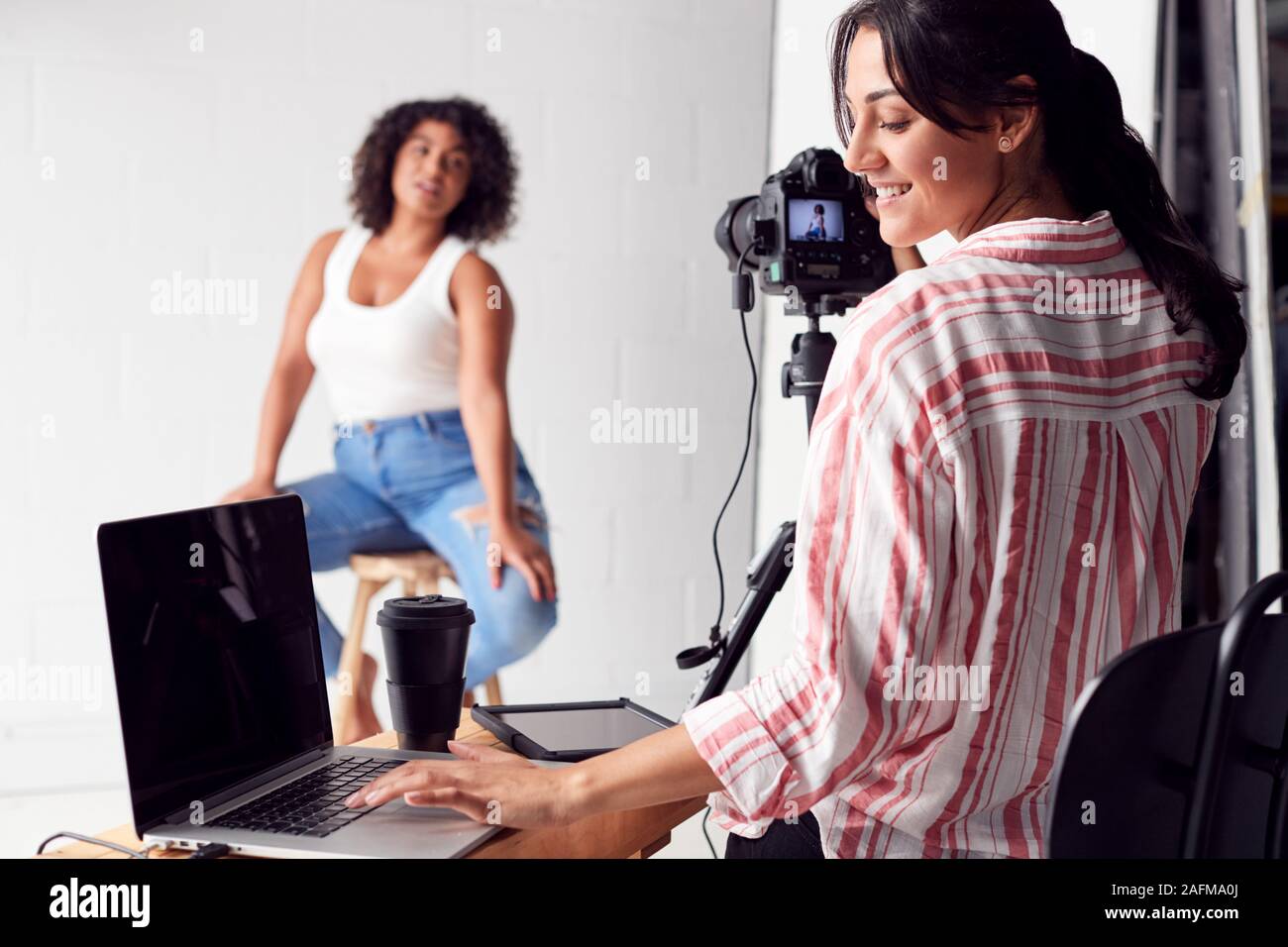 Female Photographer In Digital Studio Shooting Images On Camera ...