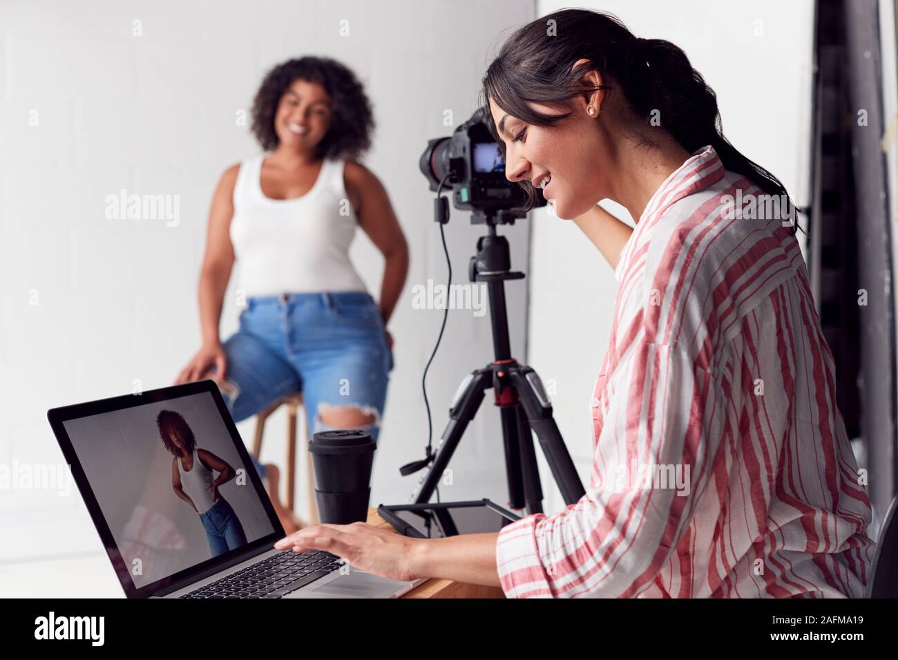 Female Photographer In Digital Studio Shooting Images On Camera ...