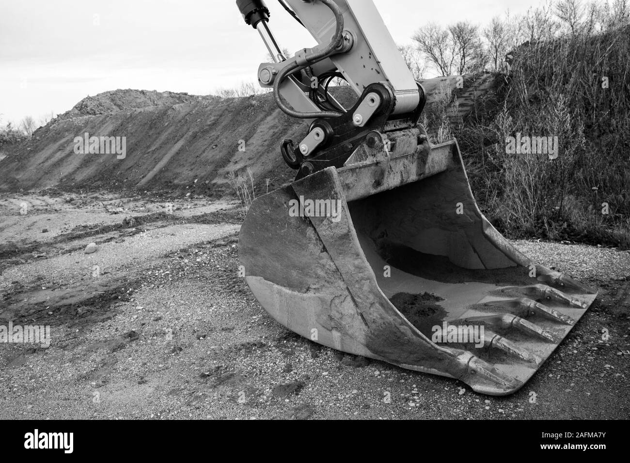 an big digger with a big shovel removes a mountain of earth Stock Photo ...