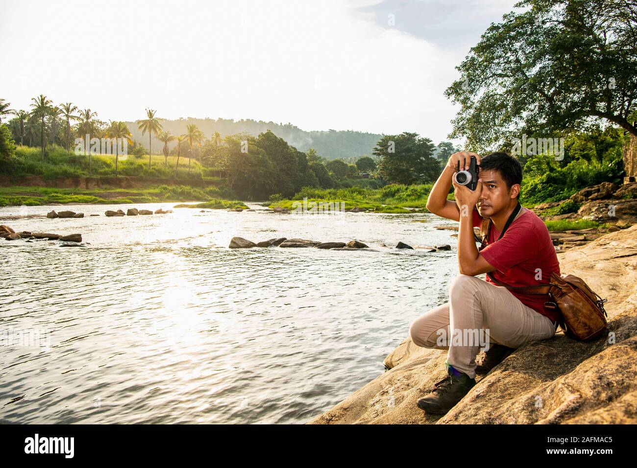 Man taking picture on his analog range finder camera in Pinnawala Stock ...