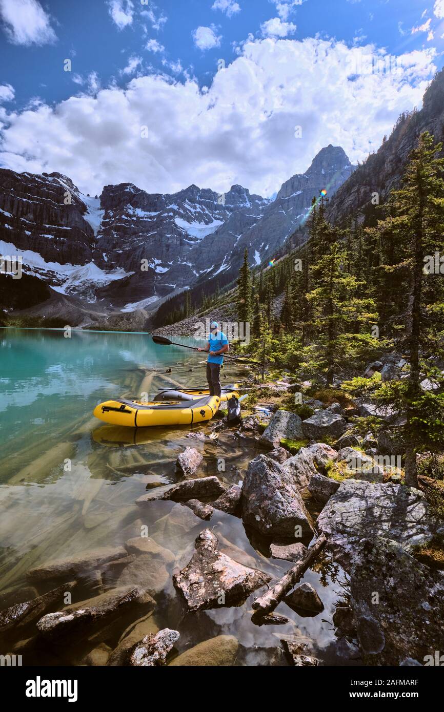 A man prepares for a rafting trip across Cirque Lake in Banff, Alberta ...