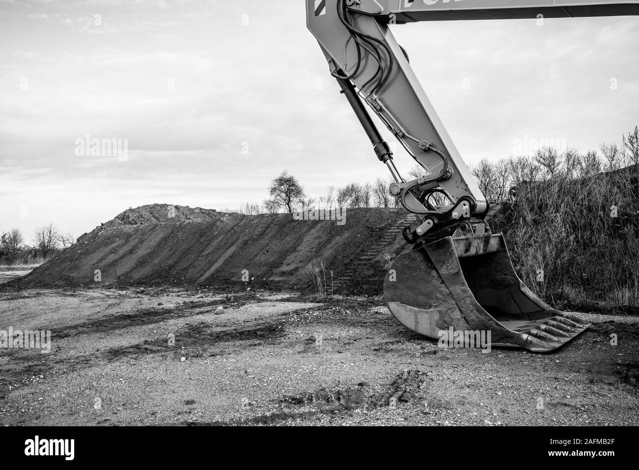 an big digger with a big shovel removes a mountain of earth Stock Photo ...