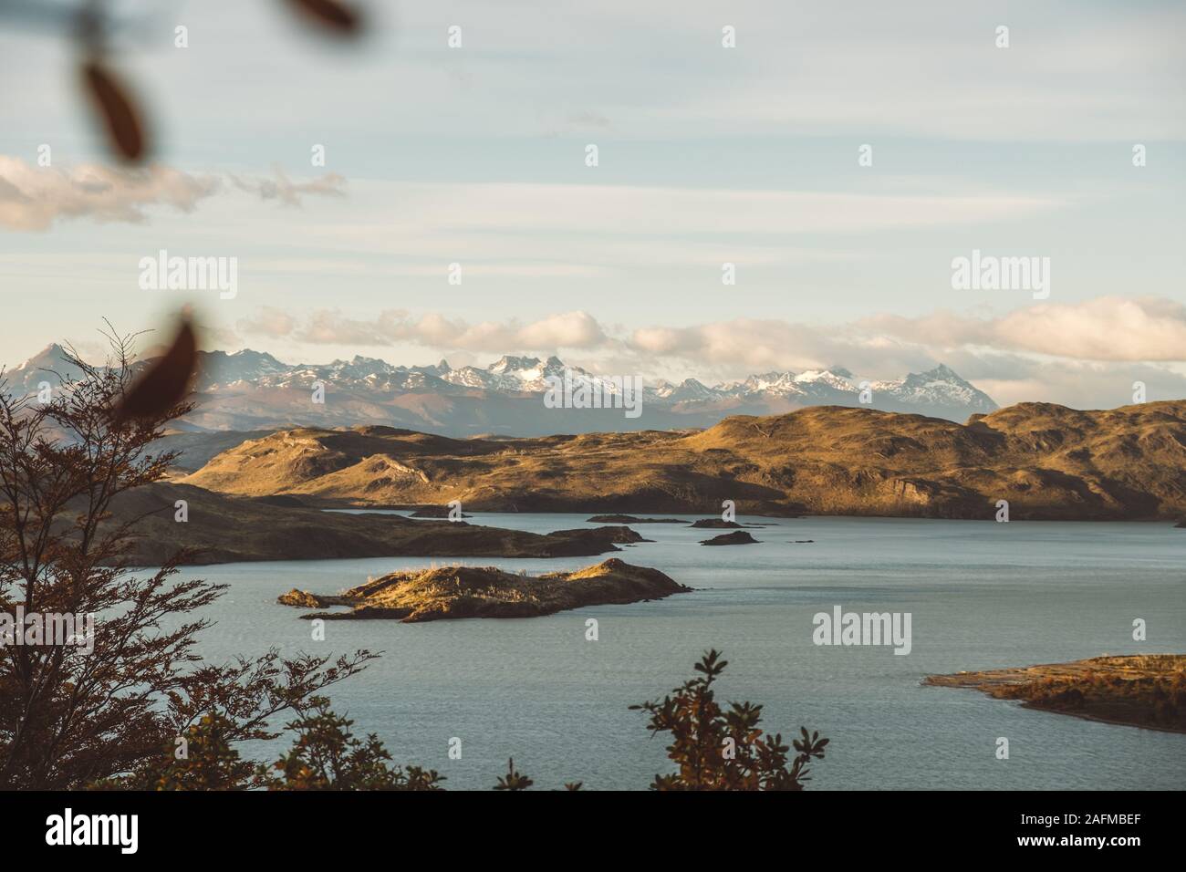 Mountain landscape through branches of trees Stock Photo - Alamy